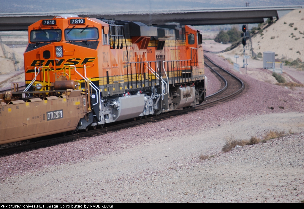 BNSF 7810 with a red over green light approaches the Hwy 58 bridge over the rail as she goes ...